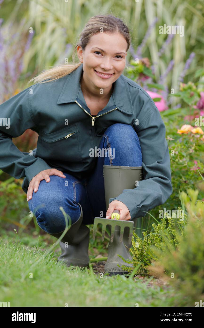 female gardener using a rake Stock Photo - Alamy