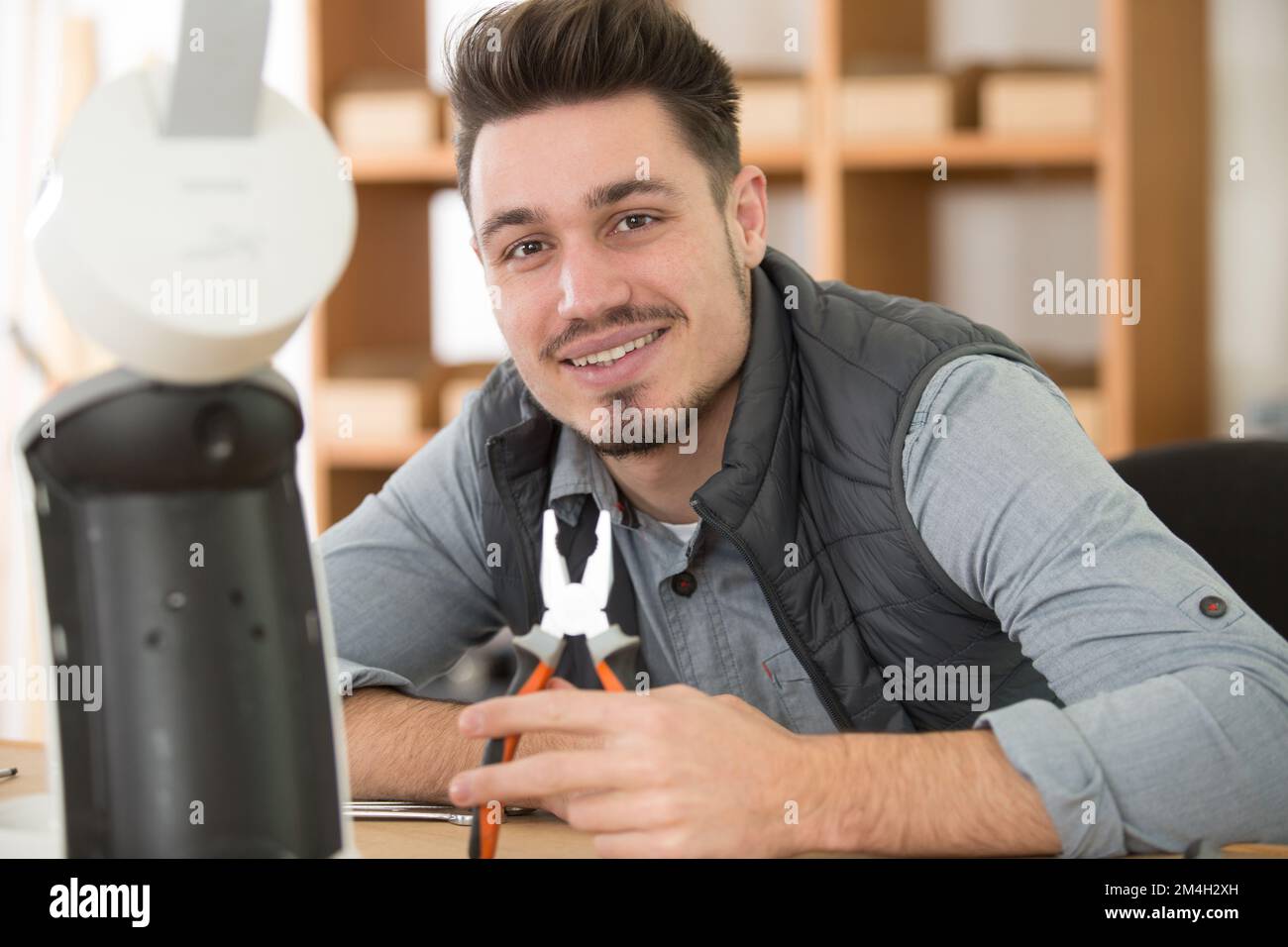 happy man repairing broken coffee machine Stock Photo - Alamy