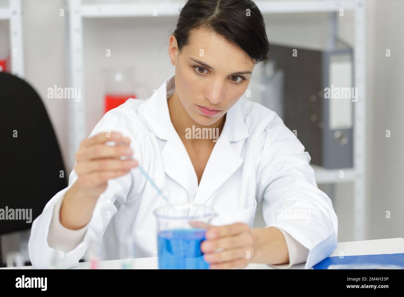 serious female worker in a lab Stock Photo - Alamy
