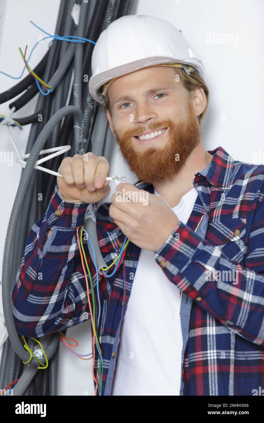 bearded male electrician working on wiring installation Stock Photo - Alamy