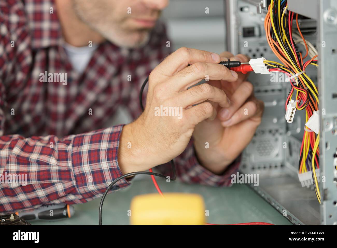 a man fixing the electronics Stock Photo - Alamy