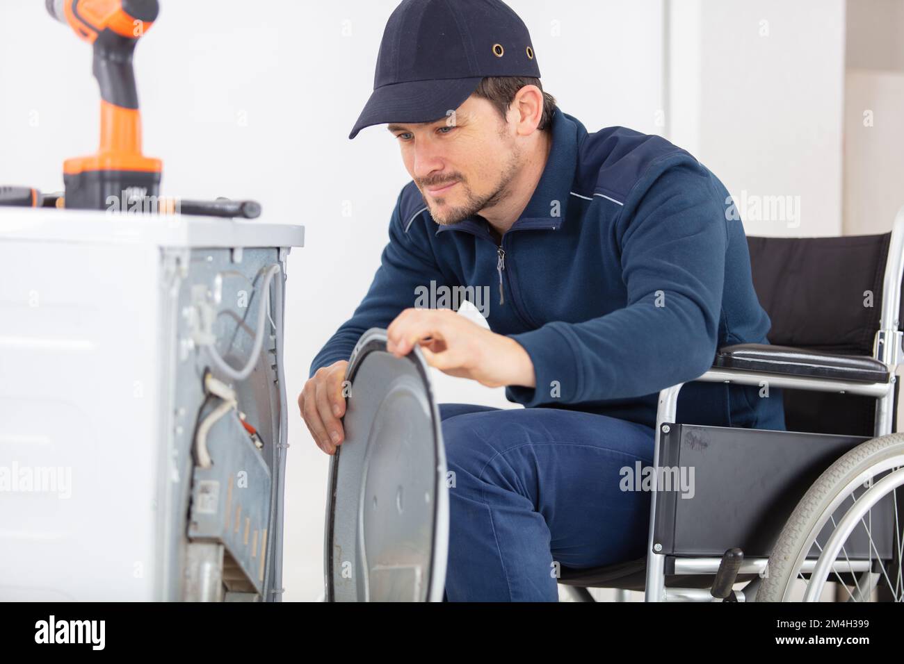 disabled man working with a drill Stock Photo - Alamy
