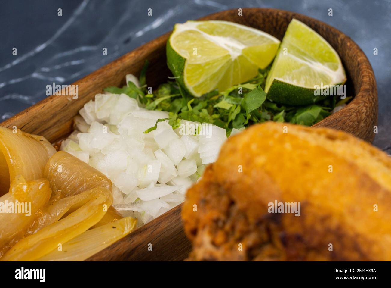 torta ahogada consome y birria, dish with onion, sweet onion and chile ...