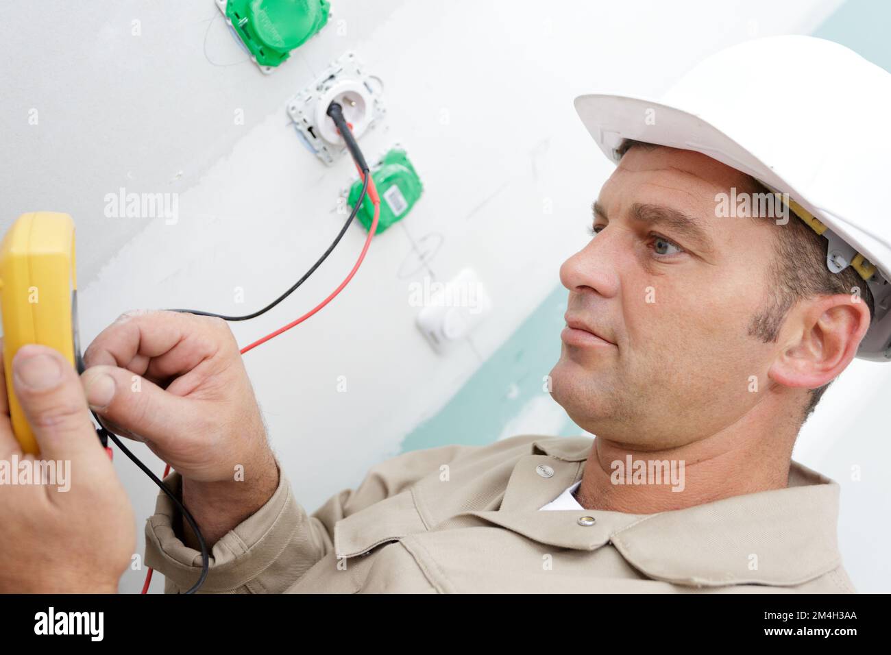 close-up of a male technician doing meter reading using mobilephone ...
