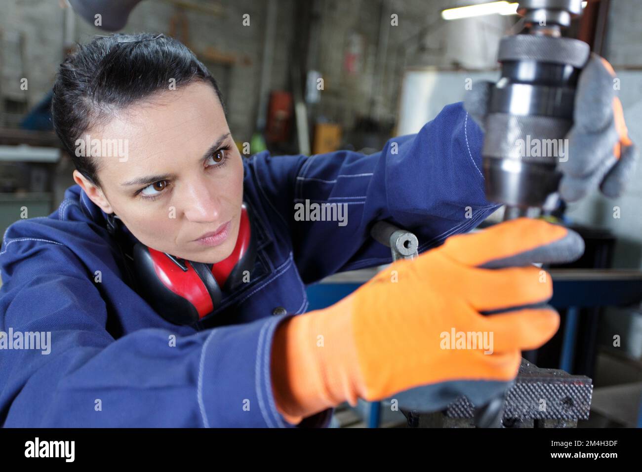 woman worker in metal workshop using pedestal drill Stock Photo - Alamy