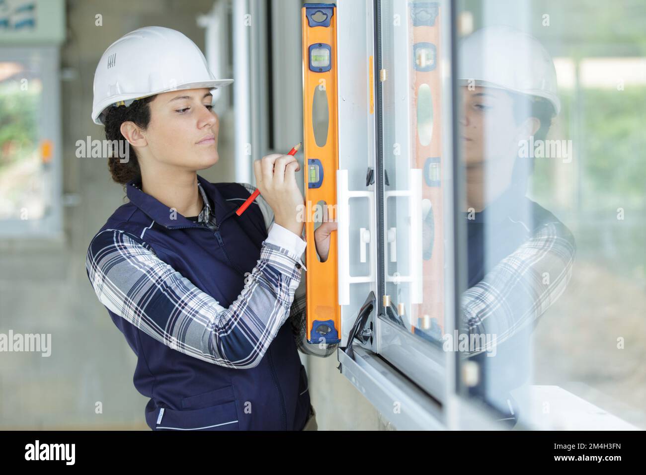professional female construction worker using a spirit level Stock ...