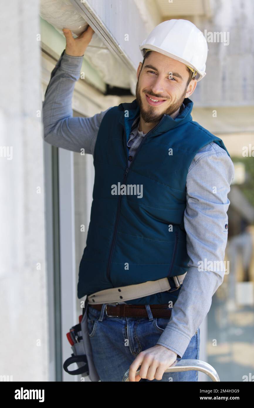 tradesman on stepladder by the outside of a building Stock Photo - Alamy