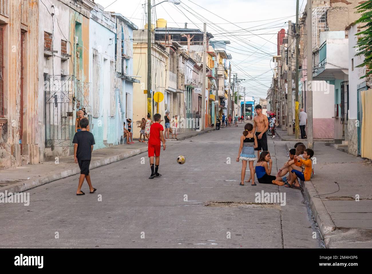 Cuban children playing on a city street, Holguin, Cuba Stock Photo - Alamy