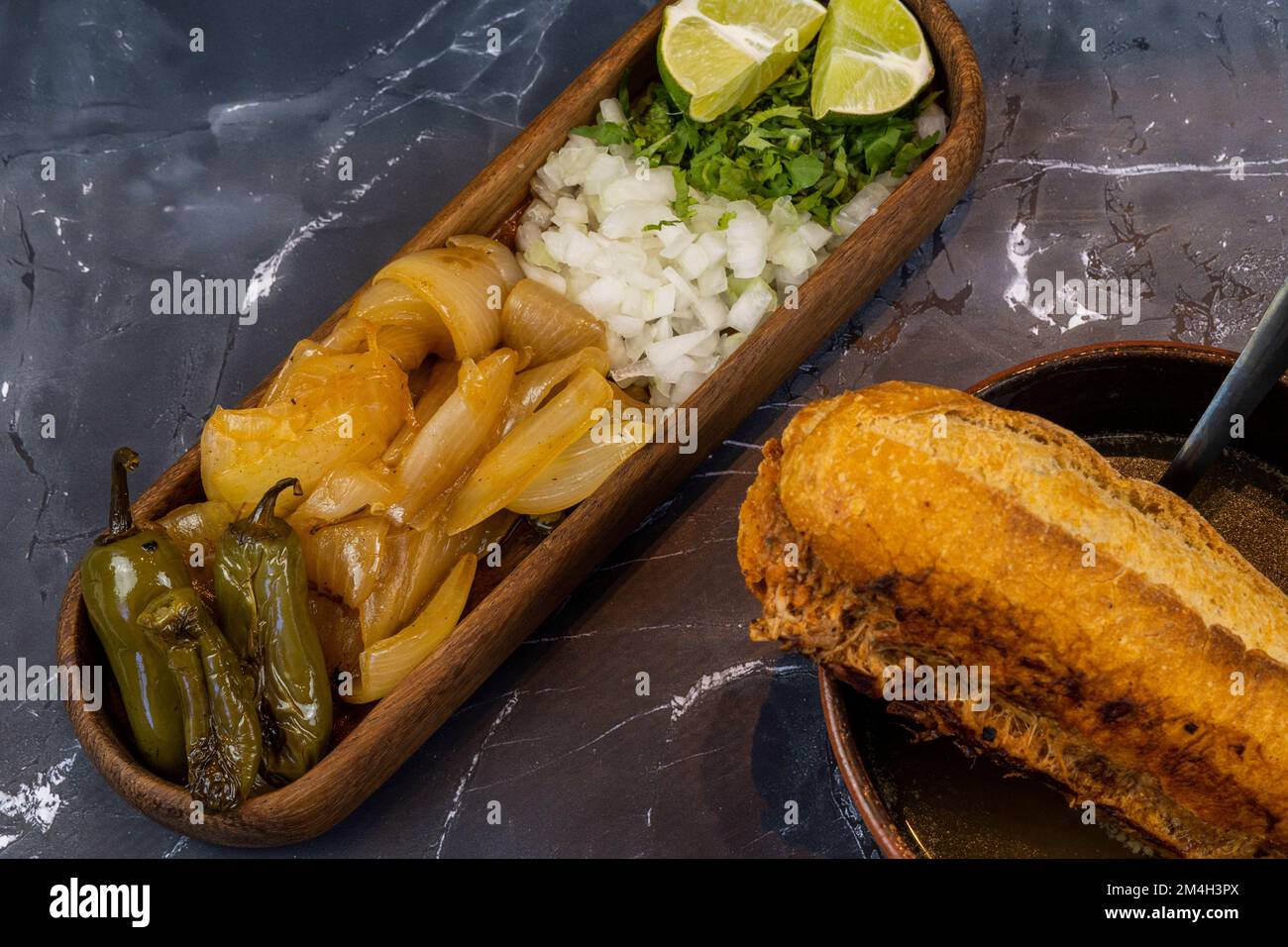 torta ahogada consome y birria, dish with onion, sweet onion and chile ...