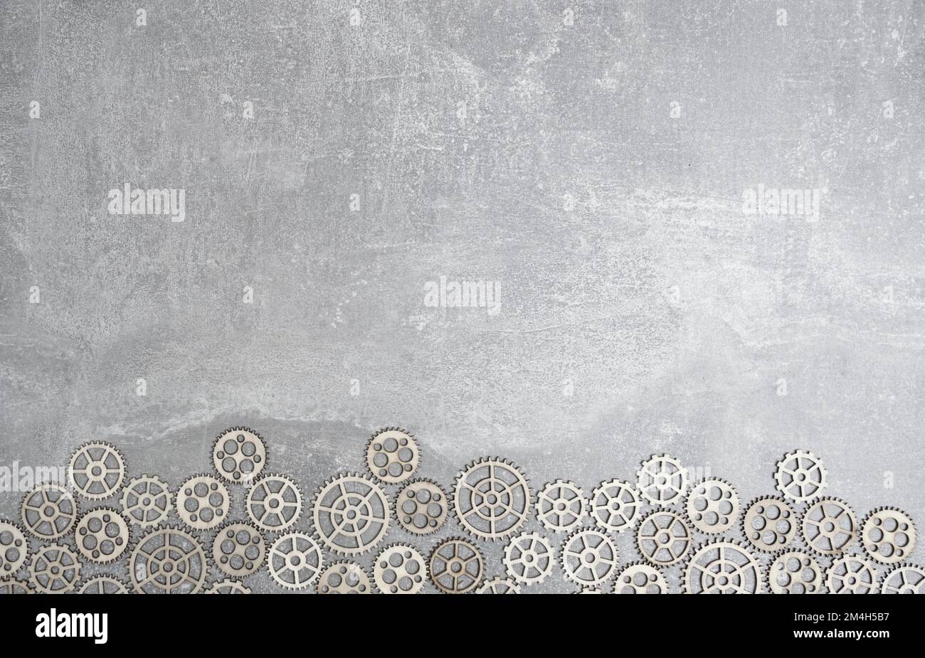 Gray concrete background with gears and copy space Stock Photo - Alamy