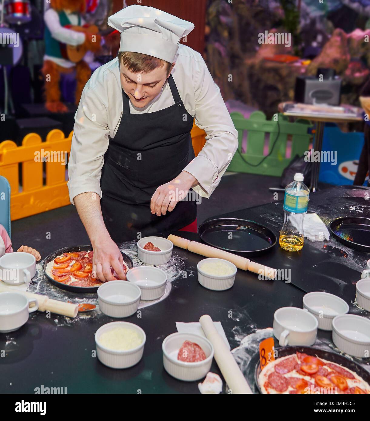 professional chef prepares pizza in a children's restaurant Stock Photo ...