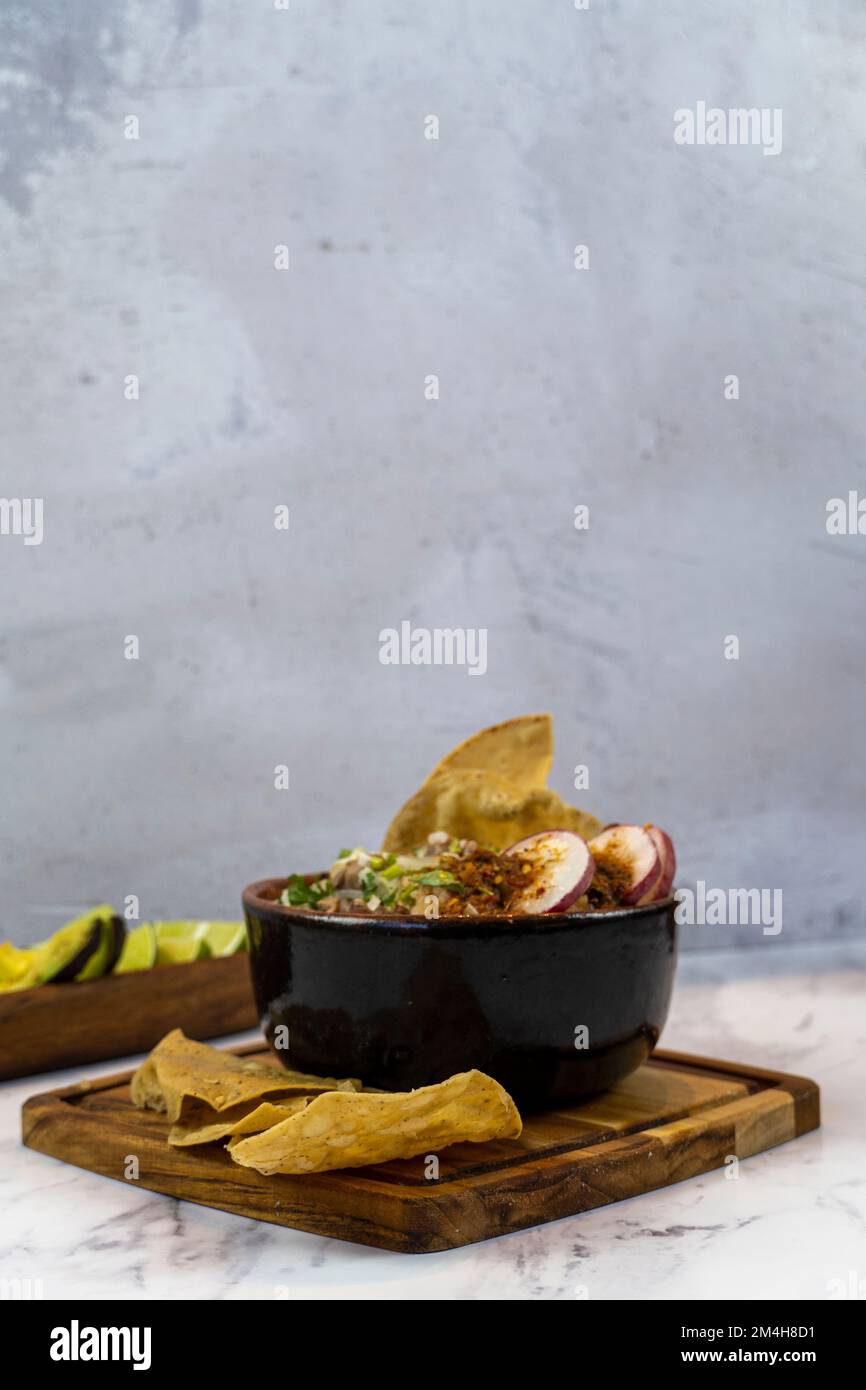 meat in its juice with golden tortilla, toasted, prepared with radishes ...
