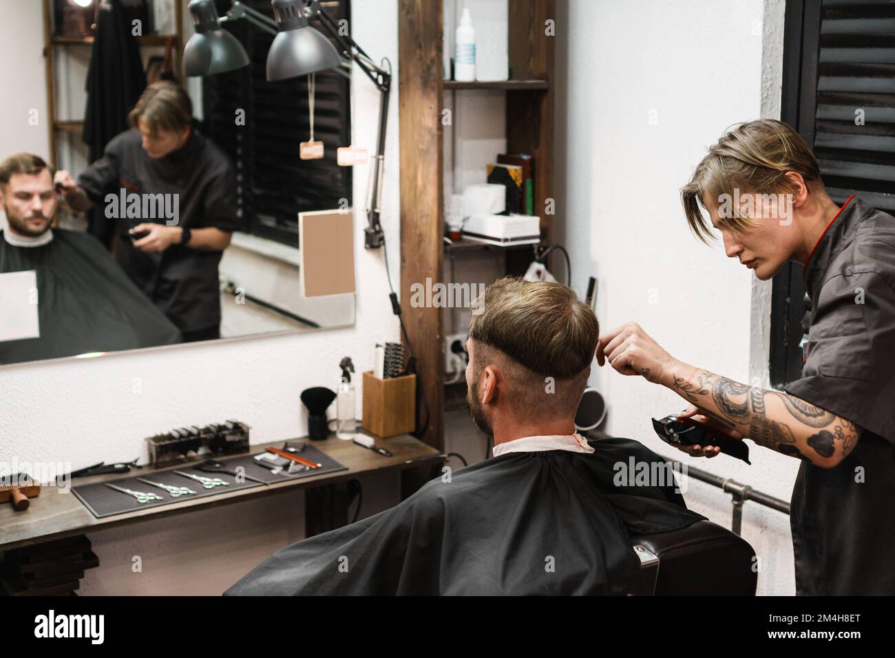 Woman barber and man customer in barber shop Stock Photo - Alamy