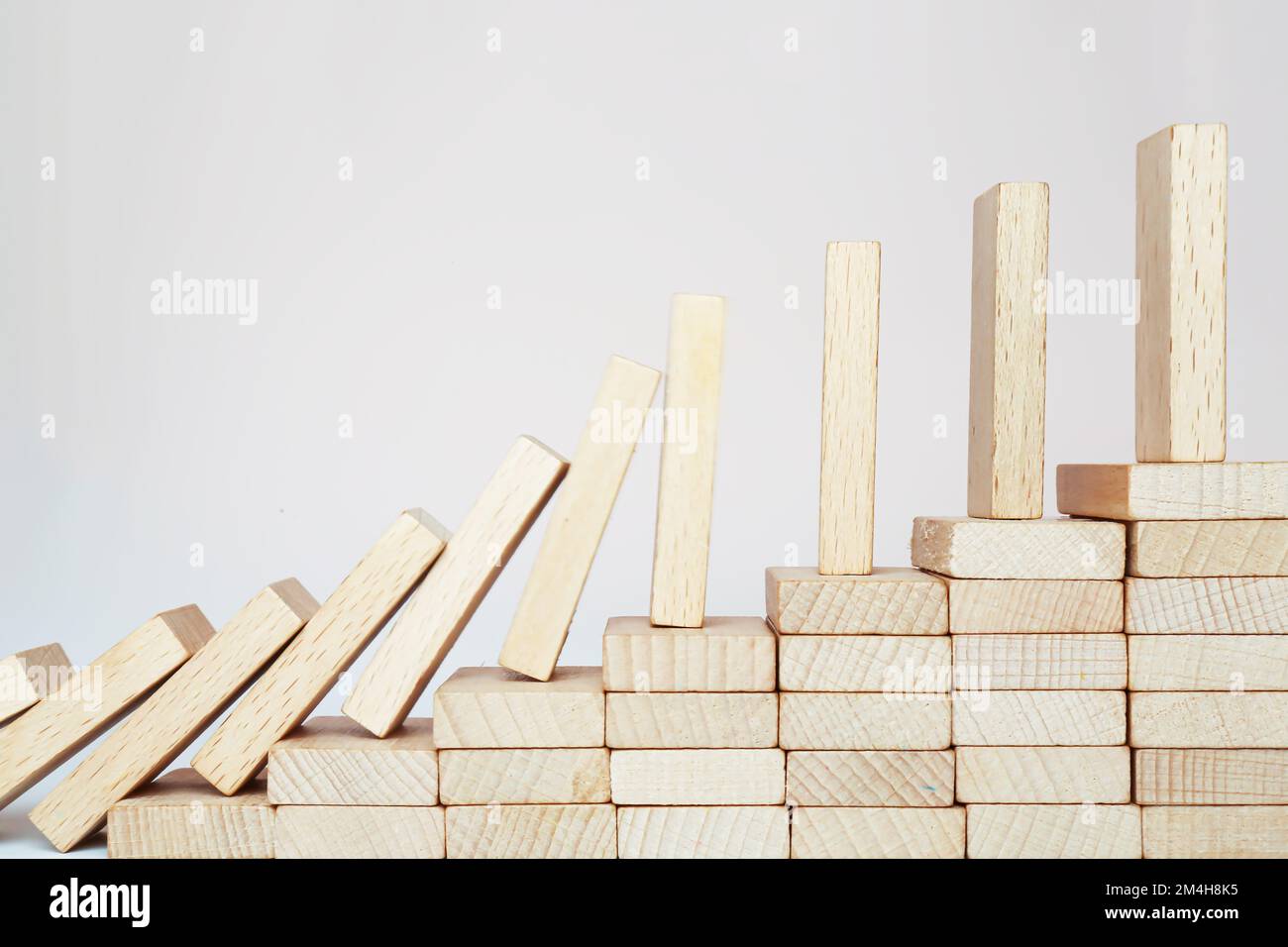 Dominoes. Domino effect climbing the stairs on a wooden staircase lined ...