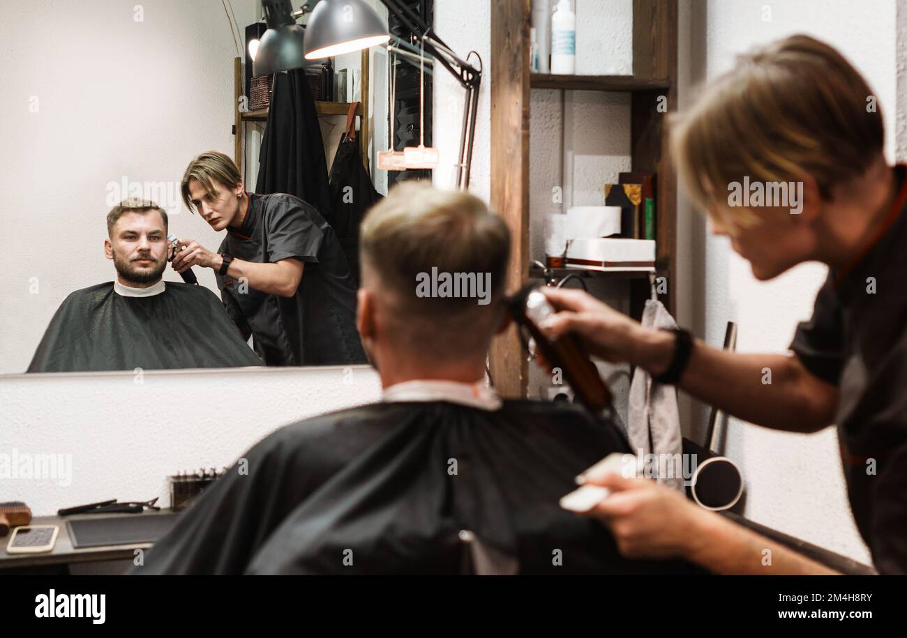 Man in barber shop reflection in mirror, focus on background Stock ...