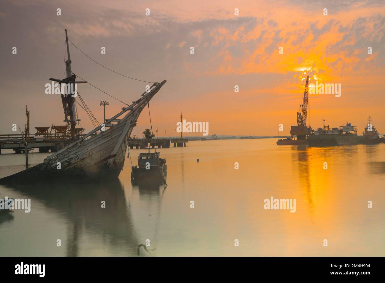 View of wooden pier on boat dock wharf in Gresik, East Java, Indonesia ...