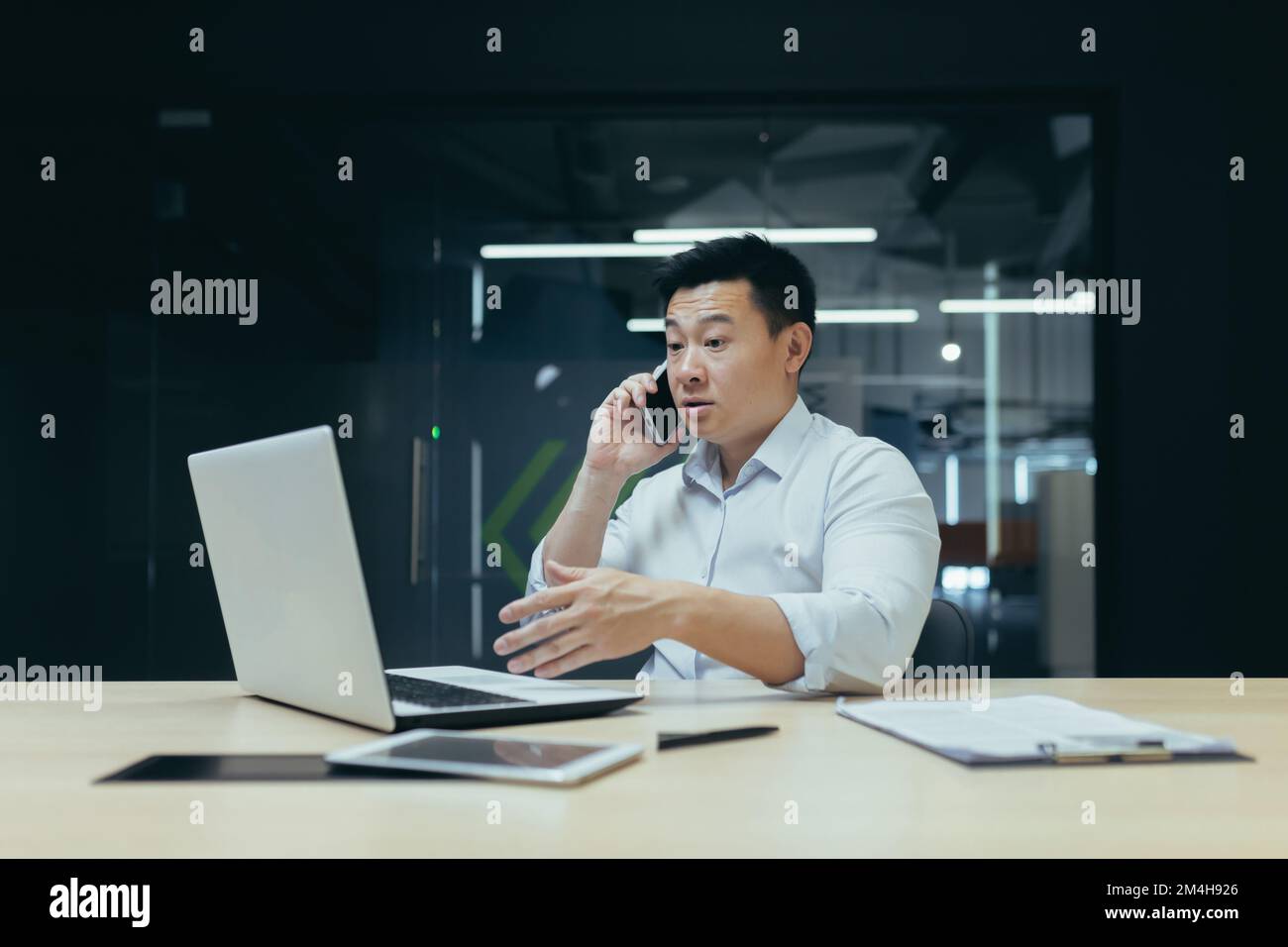 Worried man talks on smartphone hi-res stock photography and images - Alamy