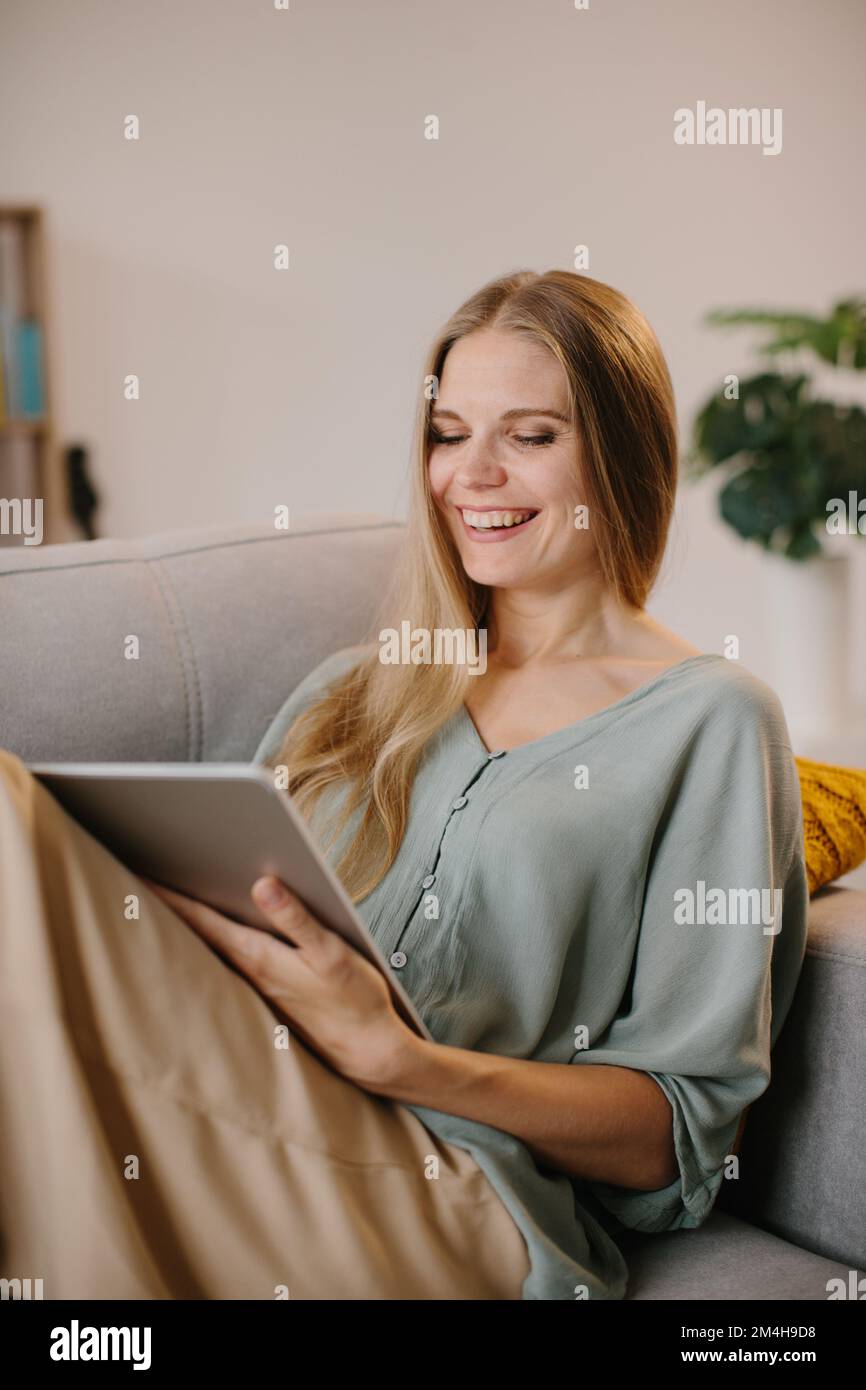 Happy young designer drawing on a graphics tablet with a stylus pen ...