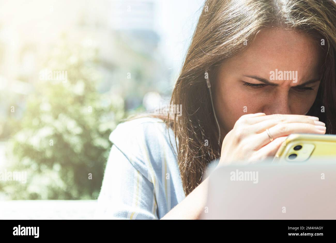 Woman looking at smartphone and closing screen with her hand personal ...