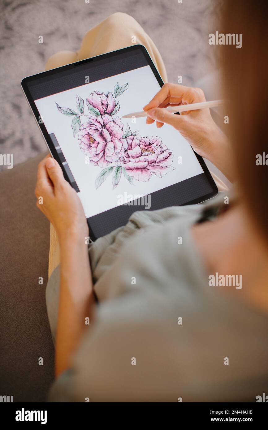 Artist or designer making new project, drawing on a graphic tablet with ...