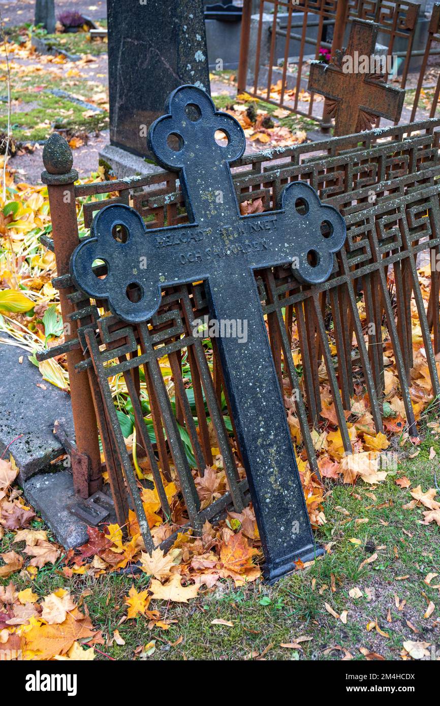 Broken old metal cross grave marker in Hietaniemi cemetery, Helsinki, Finland Stock Photo - Alamy