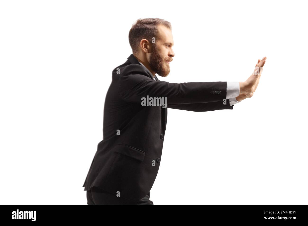 Profile shot of a businessman pushing with hands isolated on white ...