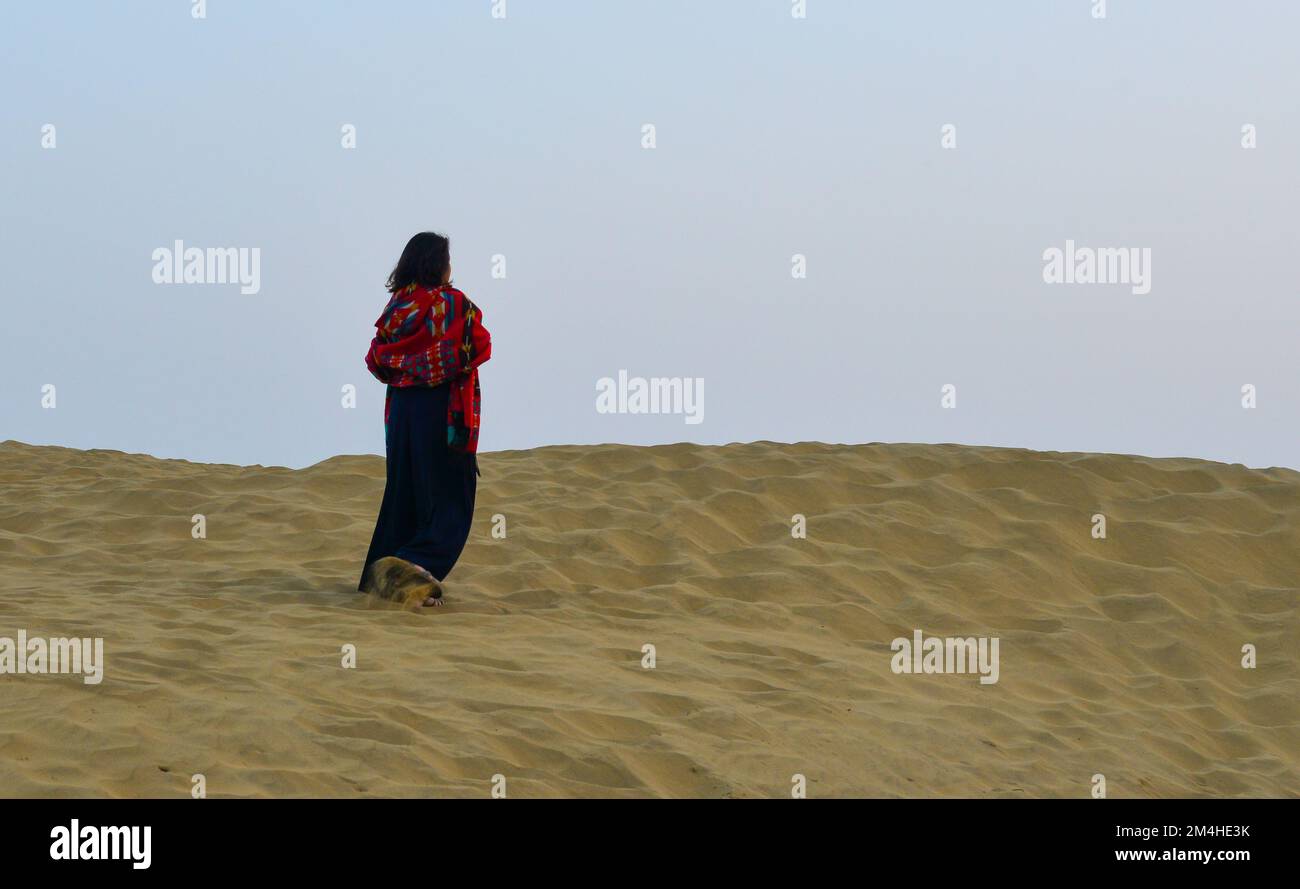 Woman standing on Thar Desert in Jaisalmer, India. Thar Desert is a ...