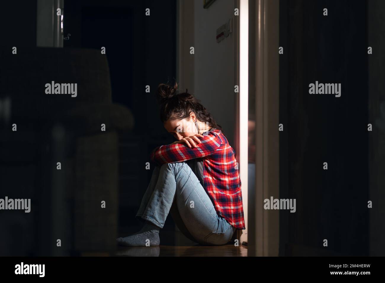 Depression and mental disorder. Young Caucasian woman sits down on ...