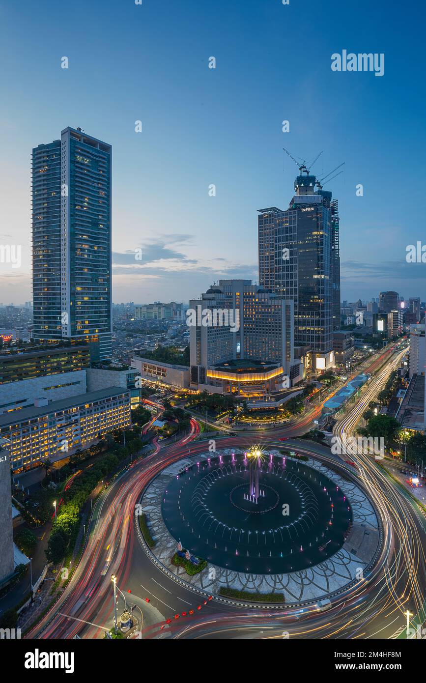 An aerial view of cityscape Jakarta surrounded by buildings with light ...