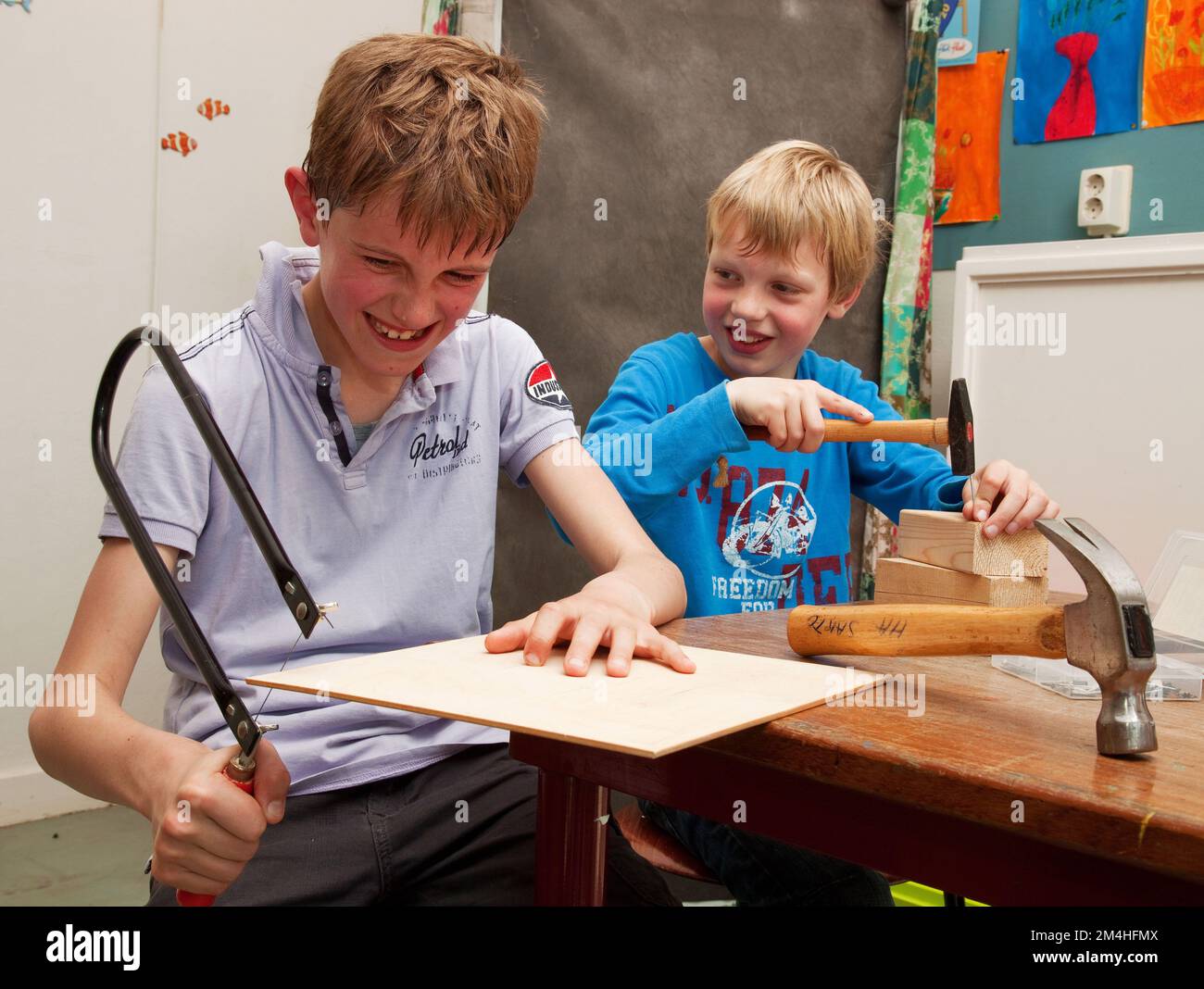 Netherlands, Primary school boys during hands-on skills with jigsaws ...