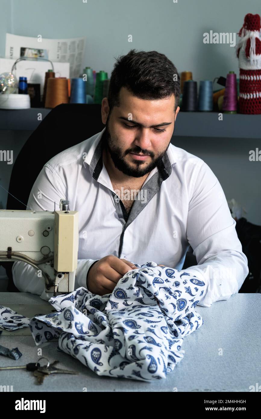 Tailor Man sewing Stock Photo - Alamy