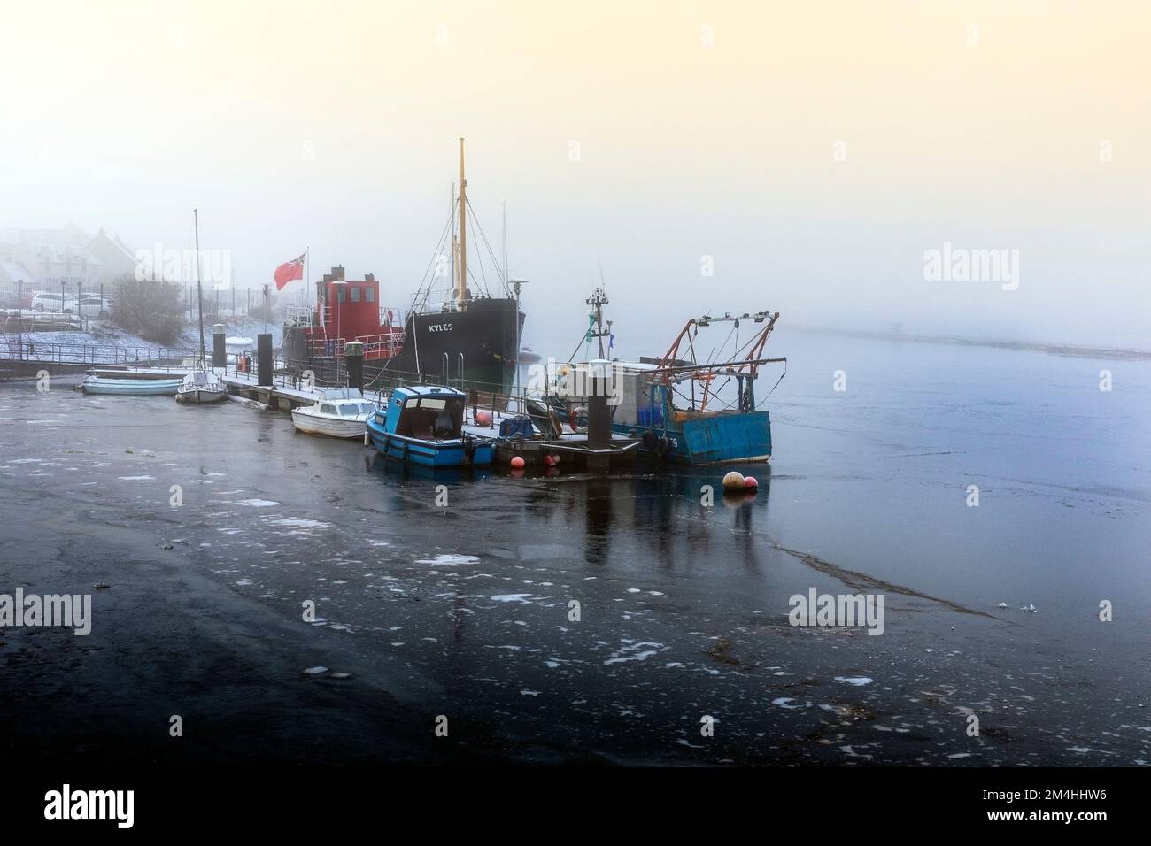 Early winter morning mist at Irvine harbour with the sea frozen around ...