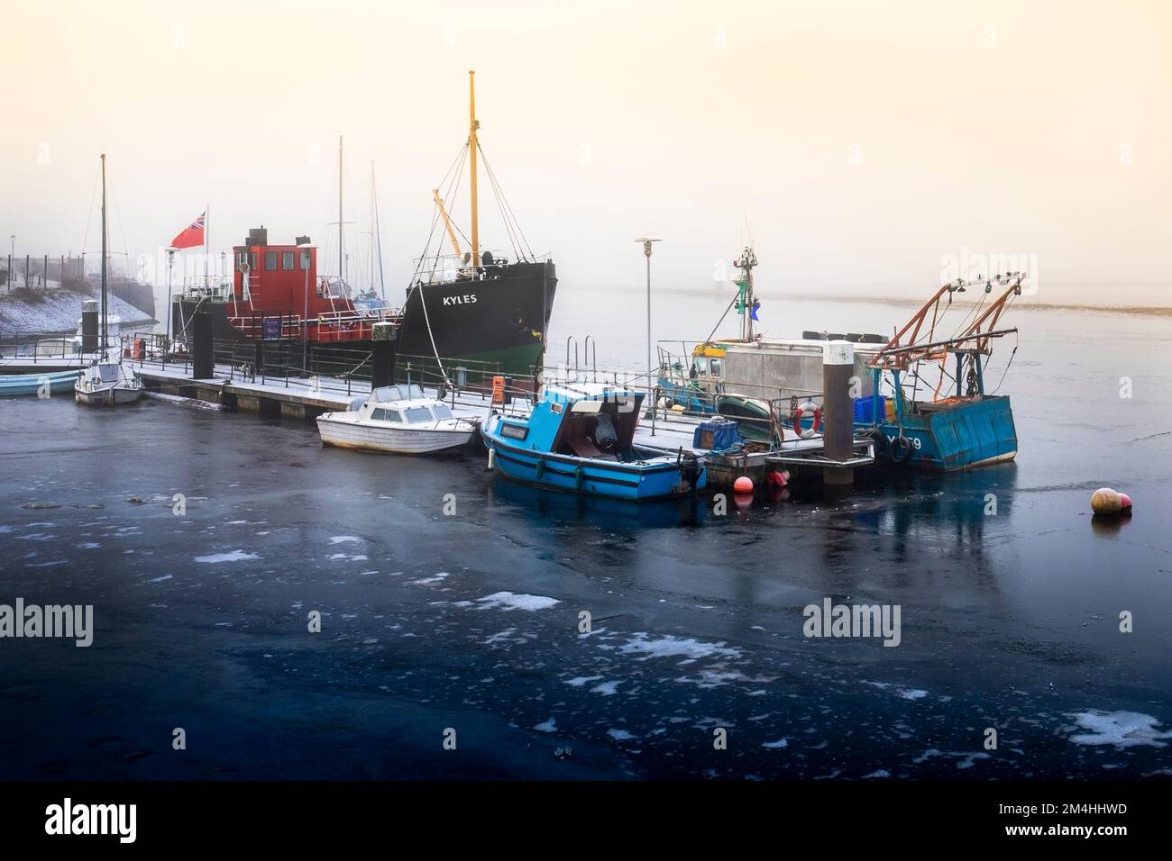 Early winter morning mist at Irvine harbour with the sea frozen around ...