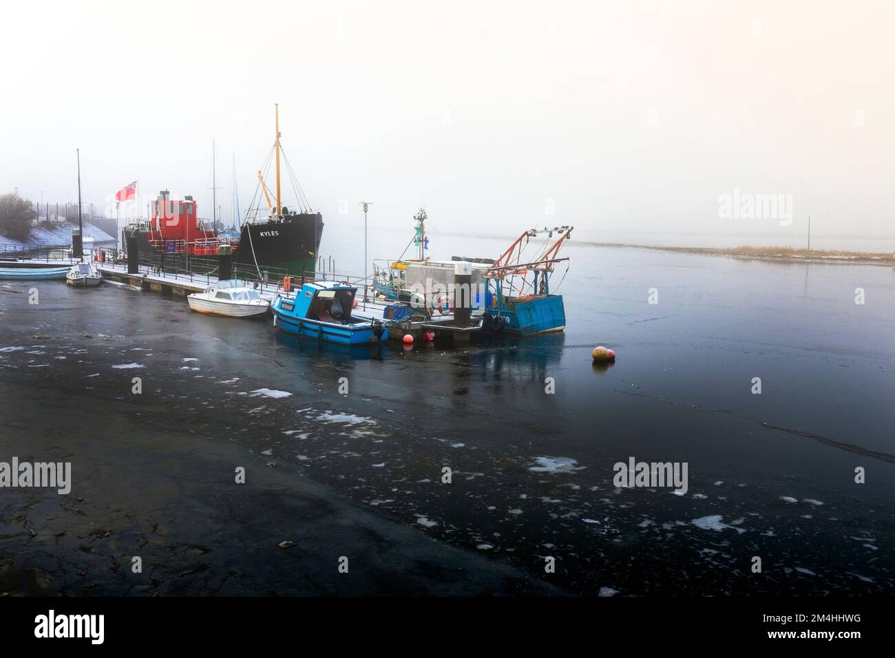 Early winter morning mist at Irvine harbour with the sea frozen around ...