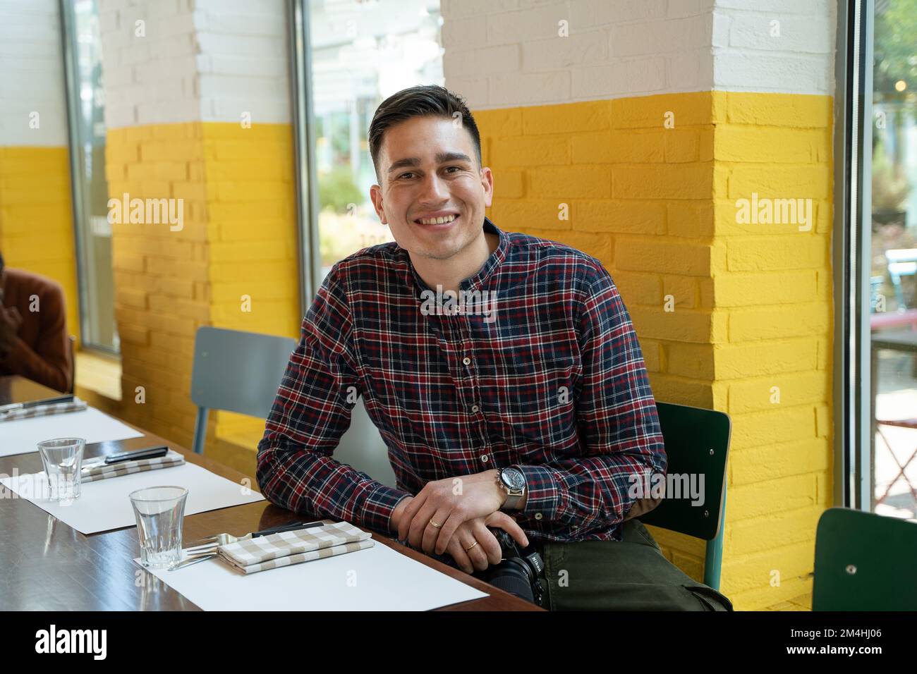 Young latin american smiling boy waiting for lunch at a public canteen ...