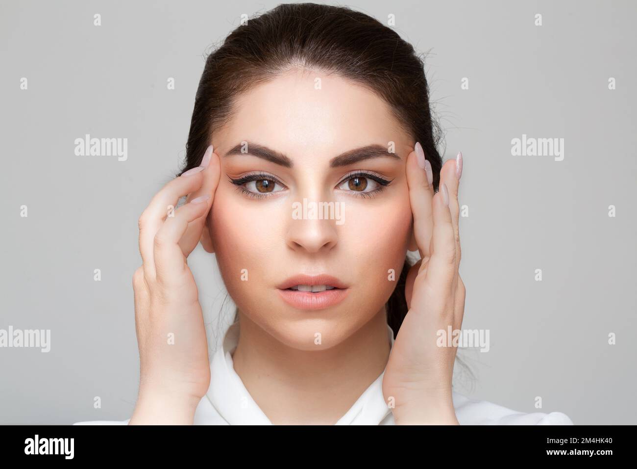 Female woman portrait getting a face massage on temples to mitigate ...