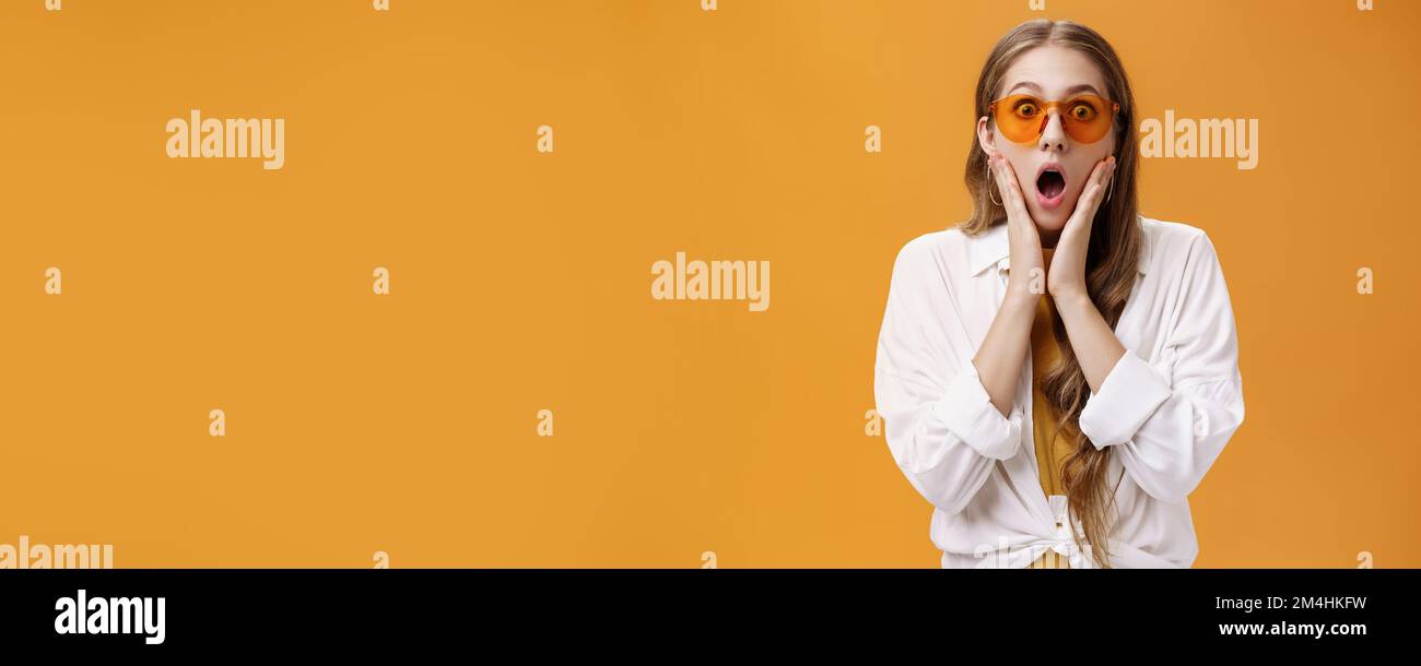 Waist-up shot of amazed and surprised party girl in trendy sunglasses ...