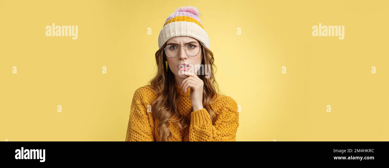 Serious-looking thoughtful smart perplexed woman solving riddle puzzle ...