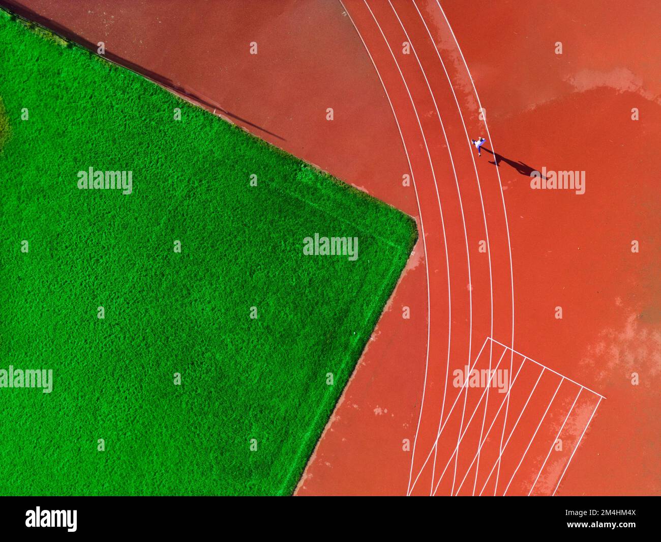 Athlete running in a stadium Stock Photo - Alamy