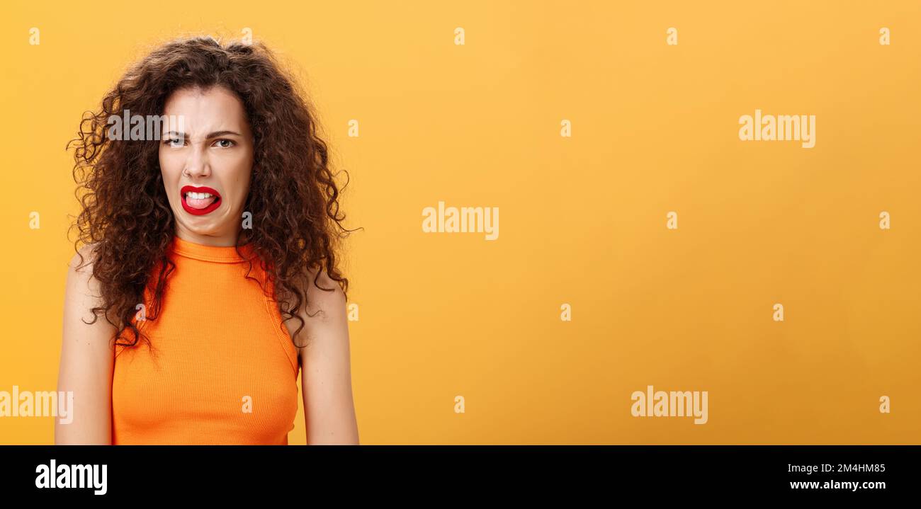 Girl being disgusted with row food sticking out tongue and frowning ...
