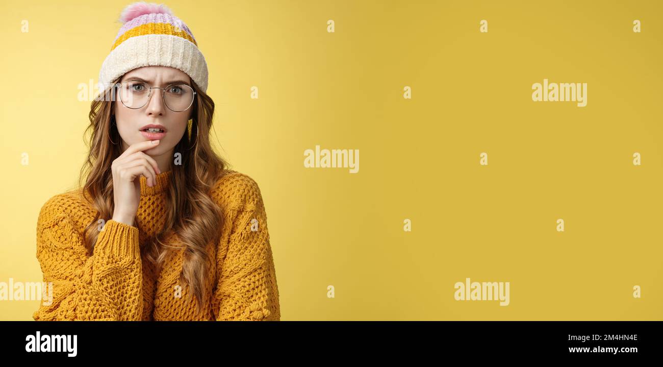 Serious-looking thoughtful smart perplexed woman solving riddle puzzle ...