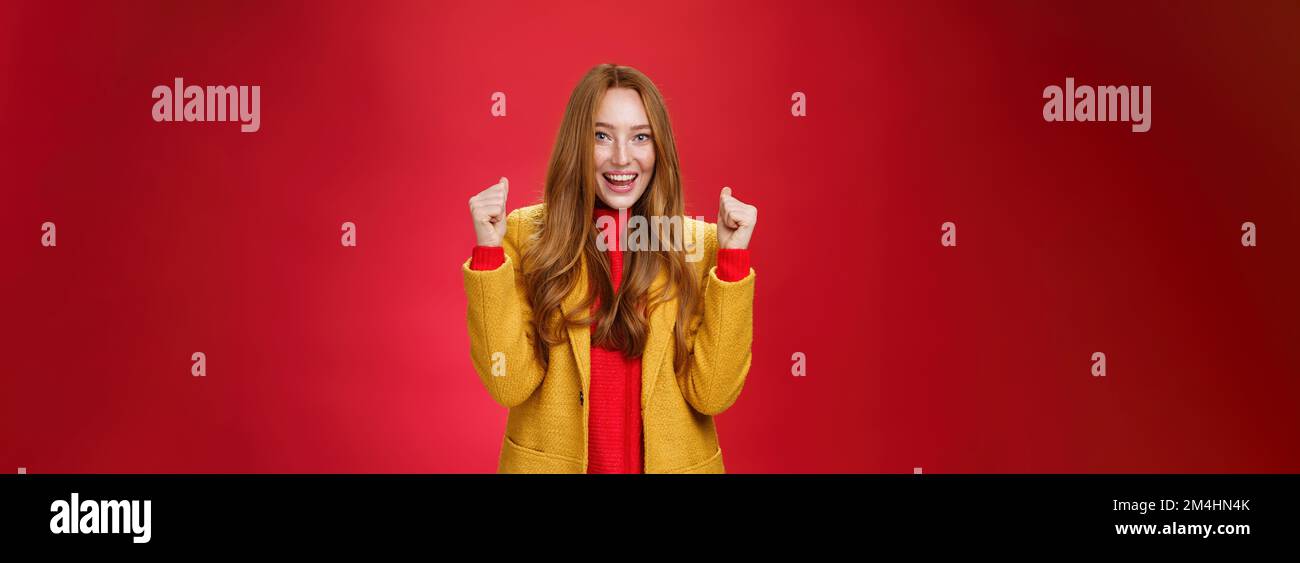 Hooray success. Portrait of happy cheerful and sincere cute ginger ...