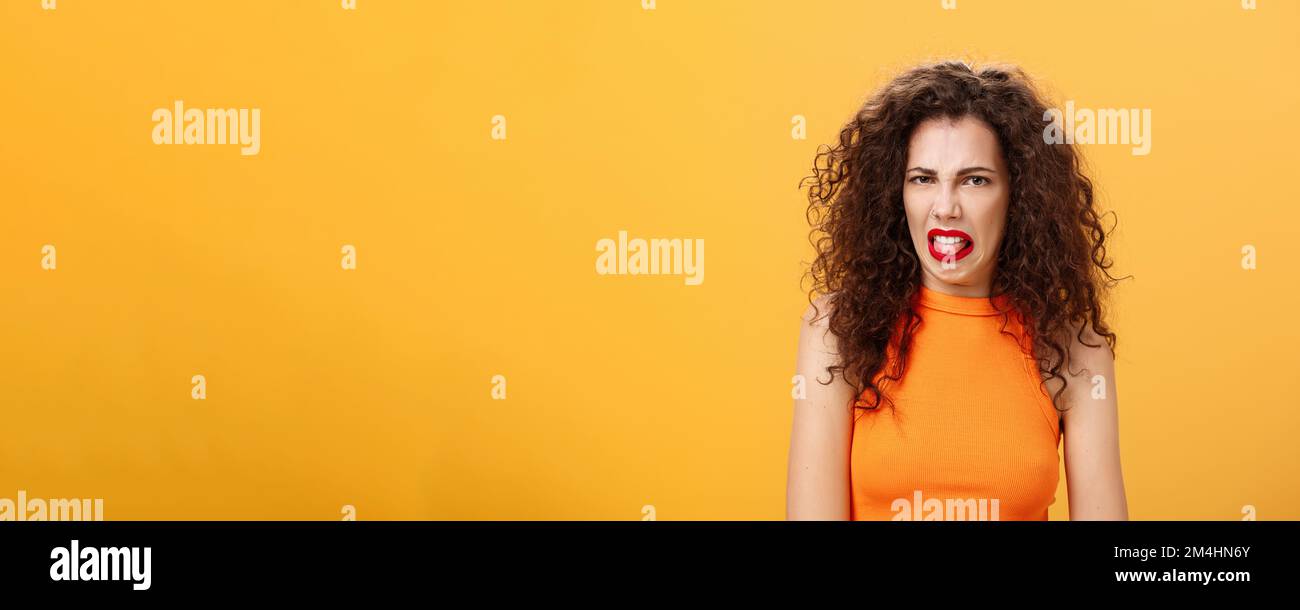 Girl being disgusted with row food sticking out tongue and frowning ...
