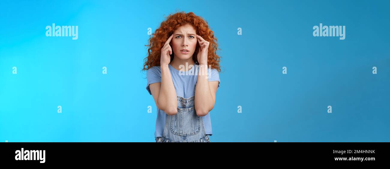 Confused panicking young distressed redhead curly girlfriend frowning ...