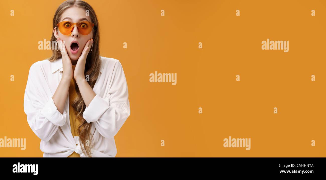 Waist-up shot of amazed and surprised party girl in trendy sunglasses ...