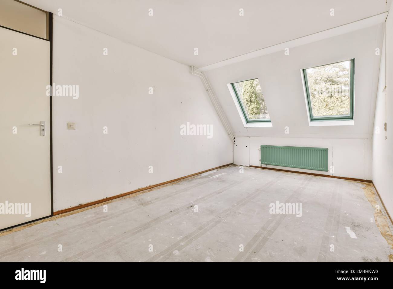 an empty room with white walls and wood flooring on the right, there is ...