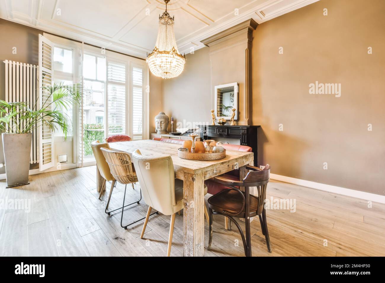 a dining room with wood flooring and walls painted in light brown ...