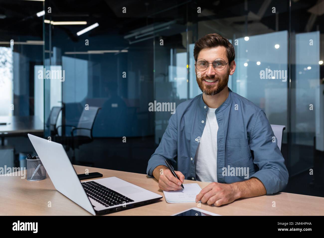 Portrait of successful businessman behind paper work, man in shirt ...