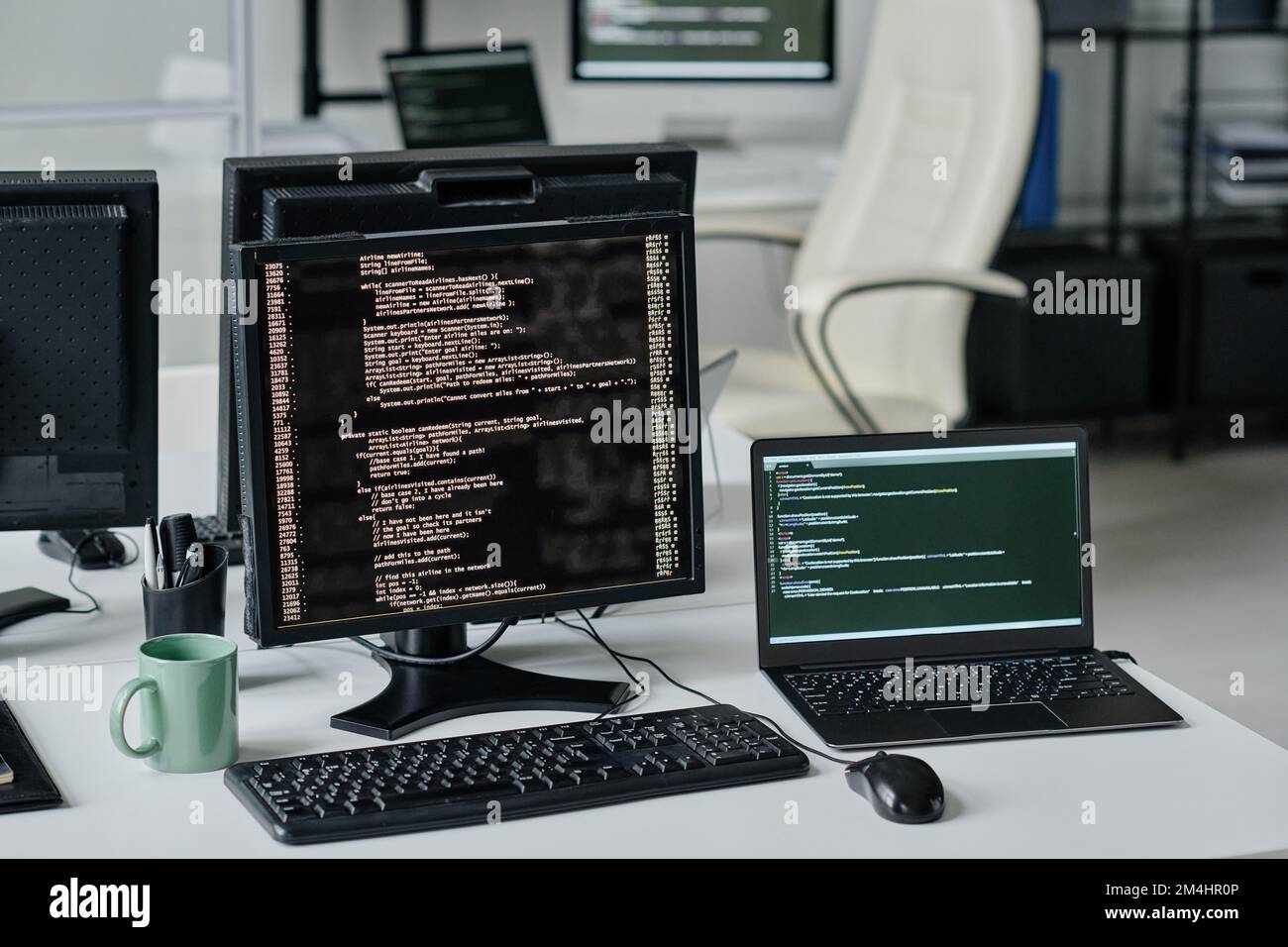 Horizontal image of computer monitors with program codes on screens in modern office Stock Photo ...