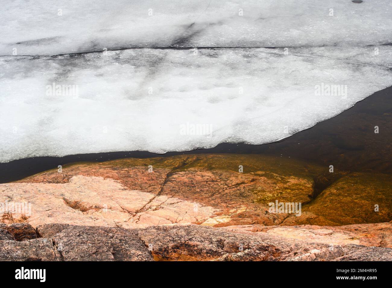 Melting ice, shoreline granite rock on Georgian Bay in early spring ...